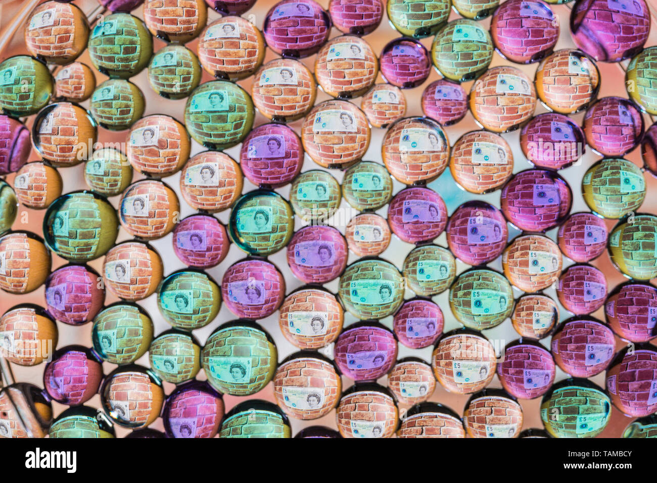 5 pound british note refracted through marble-sized spheres as ...