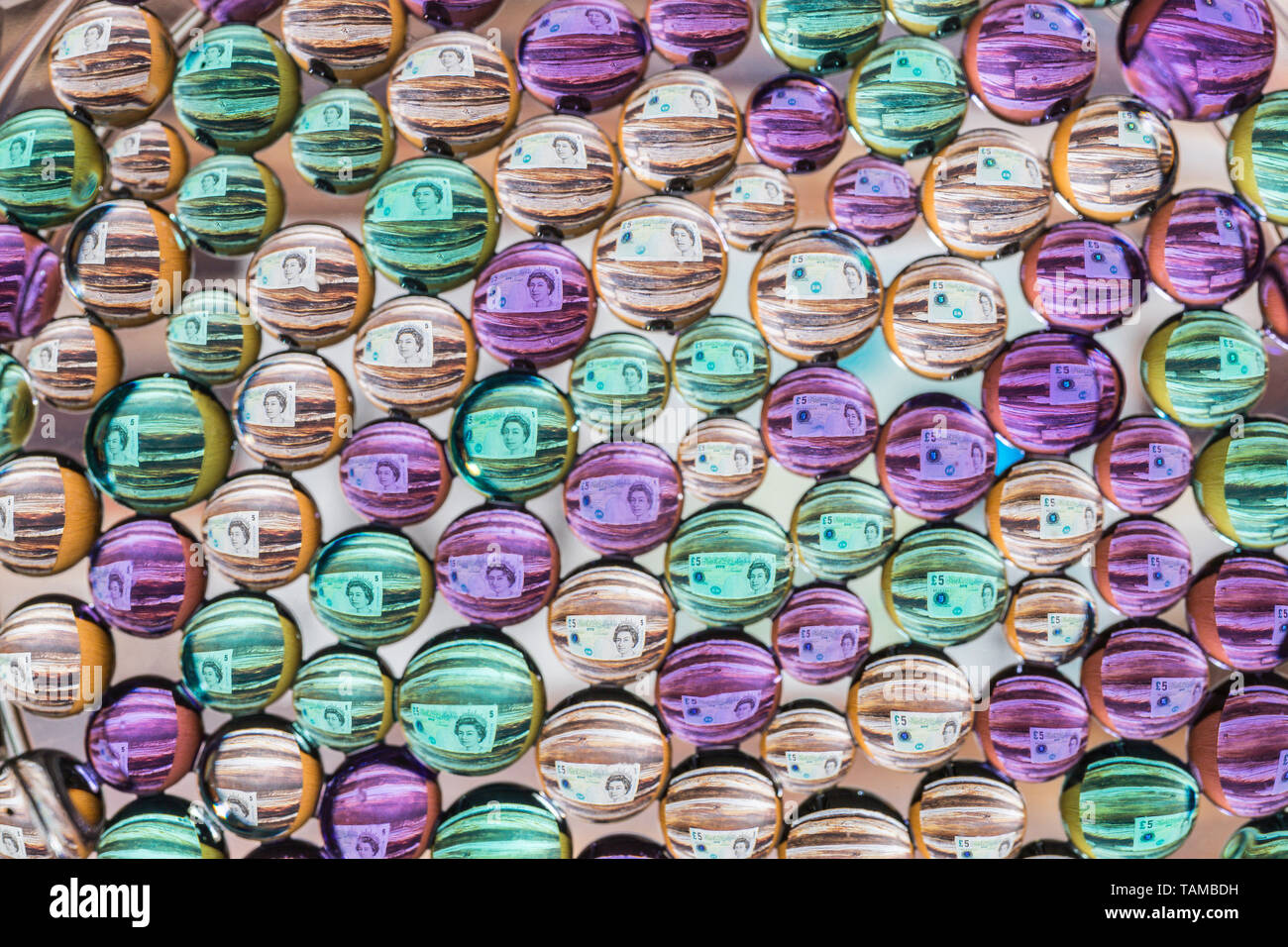 5 pound british note refracted through marble-sized spheres as ...