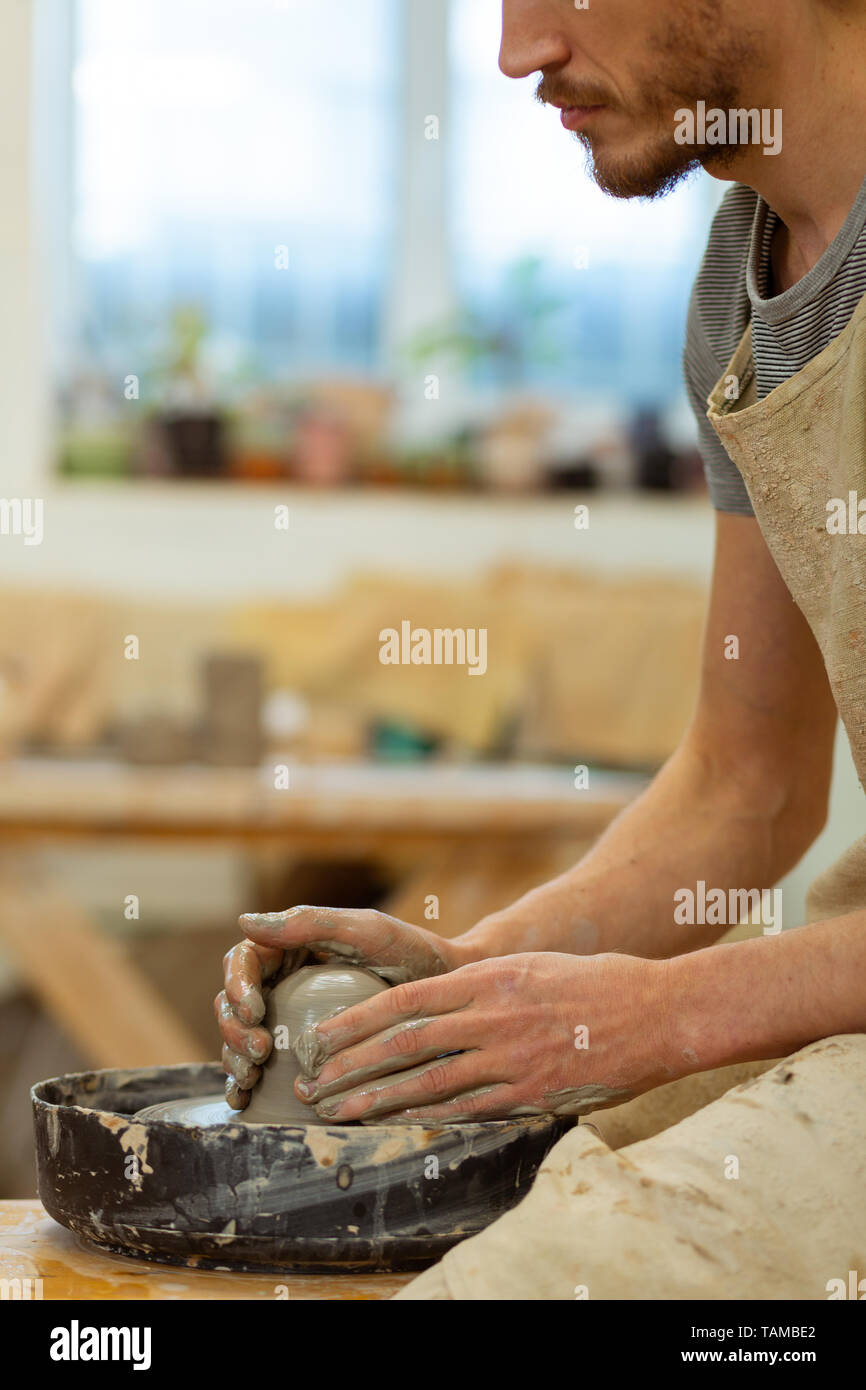 Pottery mastery. Serious bearded master showing his skills in pottery ...