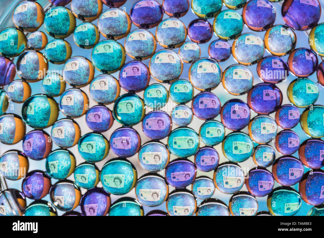 5 pound british note refracted through marble-sized spheres as ...
