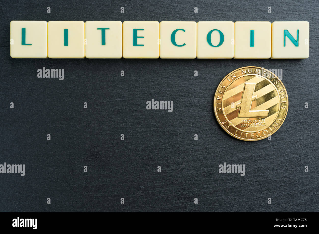 Physical Litecoin gold coin with text made out of letter tiles ...