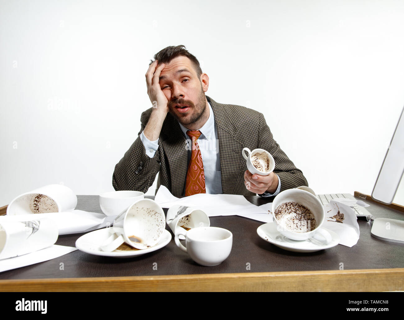 Has no time for resting. Young man drinking a lot of coffee, but can't ...