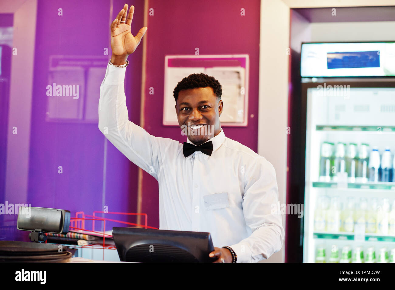 Free cashier! African american bartender wear on bow tie using cash ...