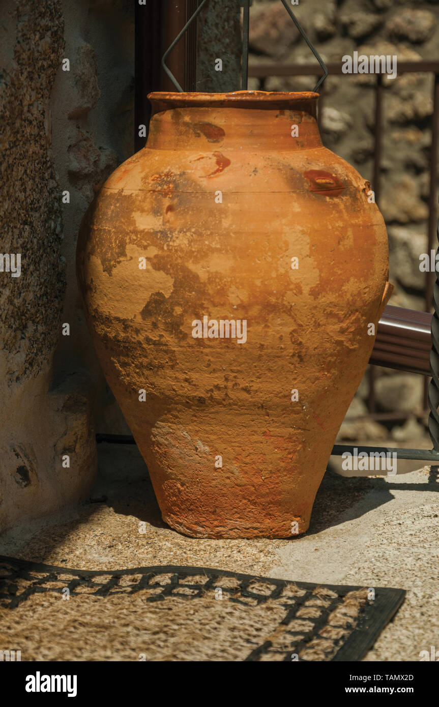 Close-up of clay pot in antique style in front of iron railing at ...