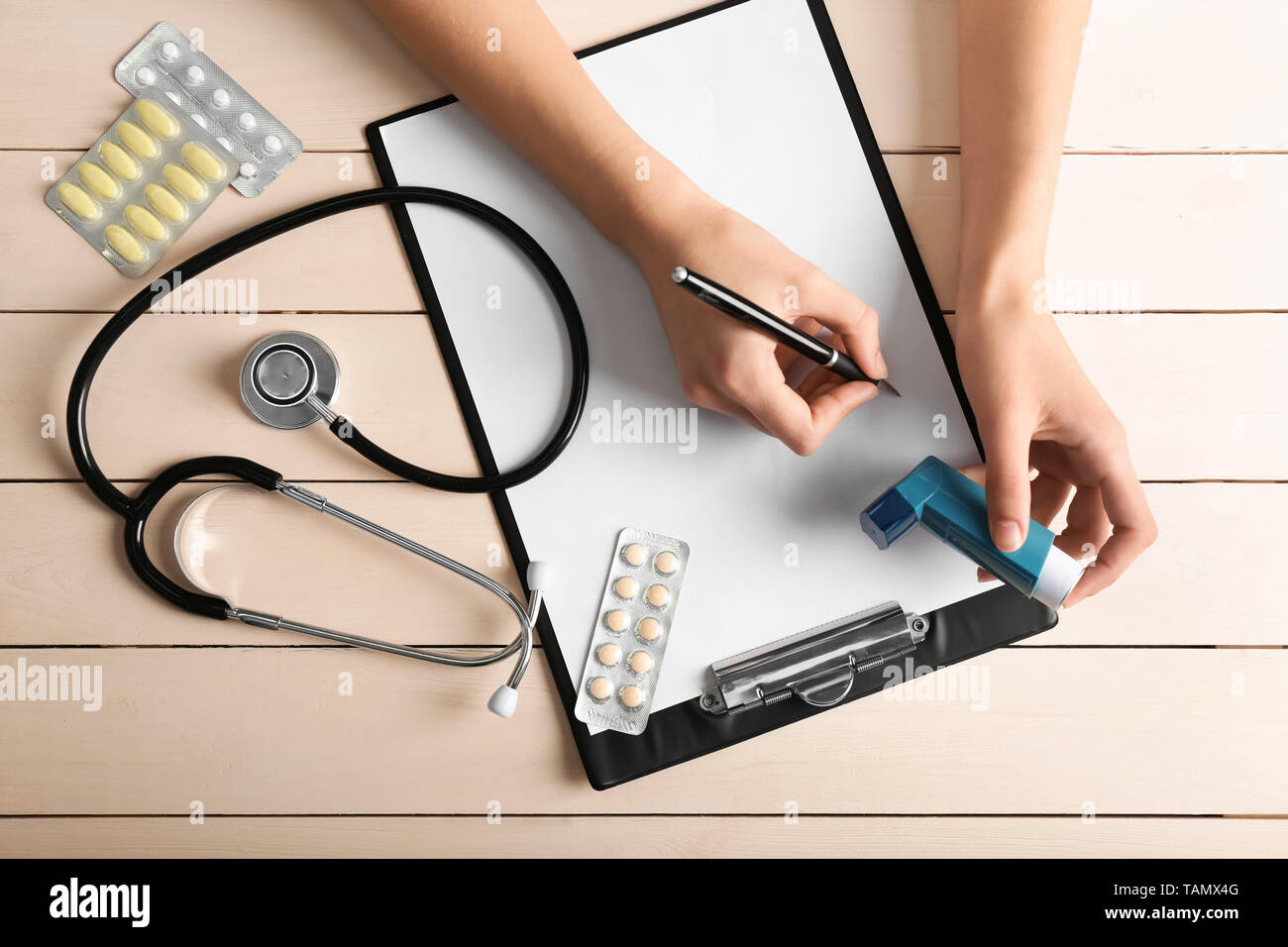 Doctor writing out prescription for using inhaler against asthma Stock ...