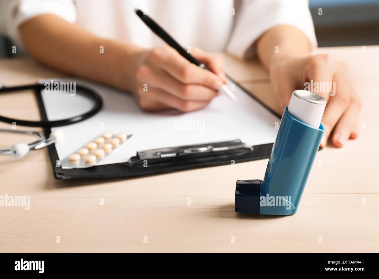 Doctor writing out prescription for using inhaler against asthma Stock ...