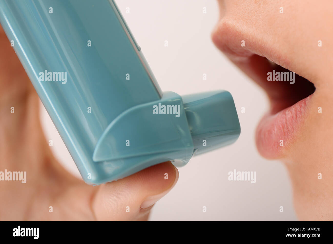 Young woman using inhaler against asthma, closeup Stock Photo - Alamy