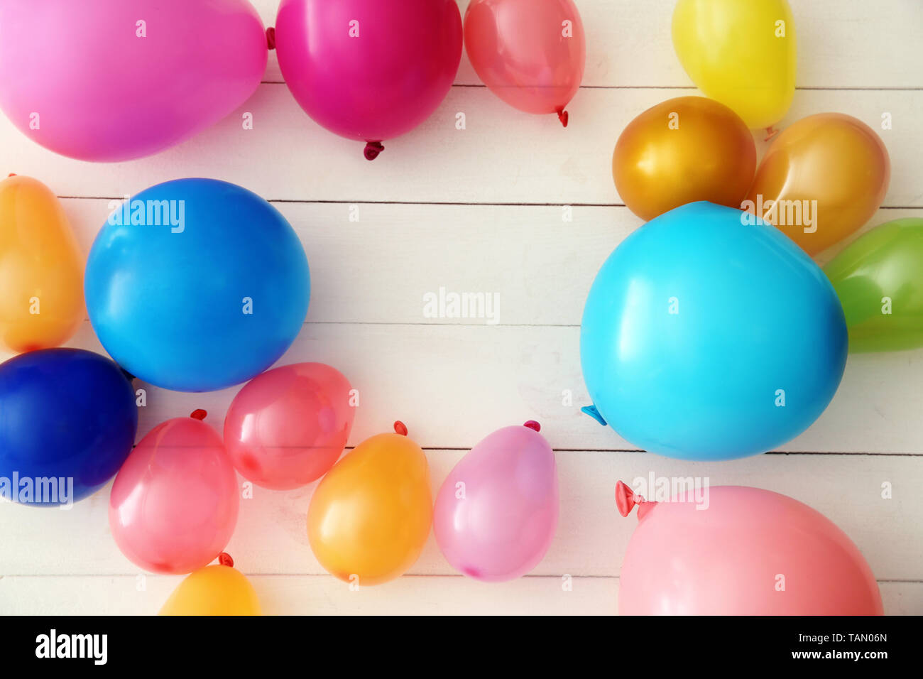 Frame made of colorful balloons on white wooden background Stock Photo ...