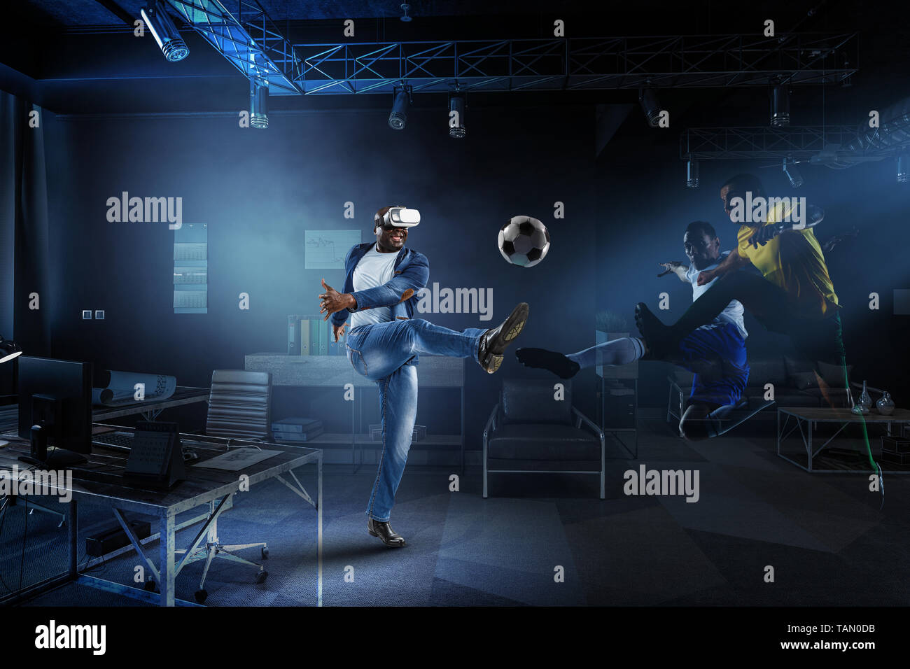 Virtual Reality headset on a black male playing football Stock Photo ...
