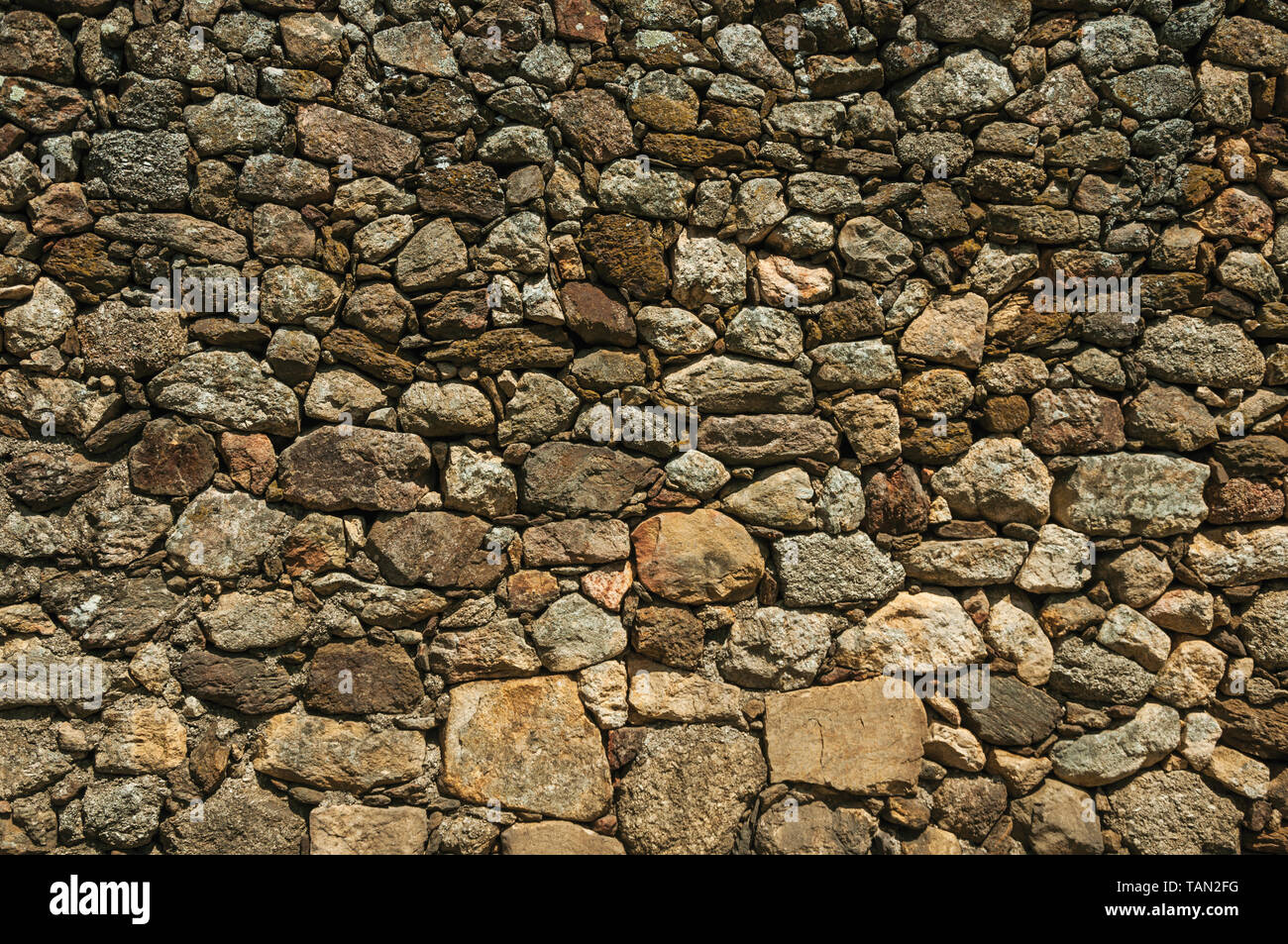 Old wall made of rough stones forming a singular background at Linhares ...