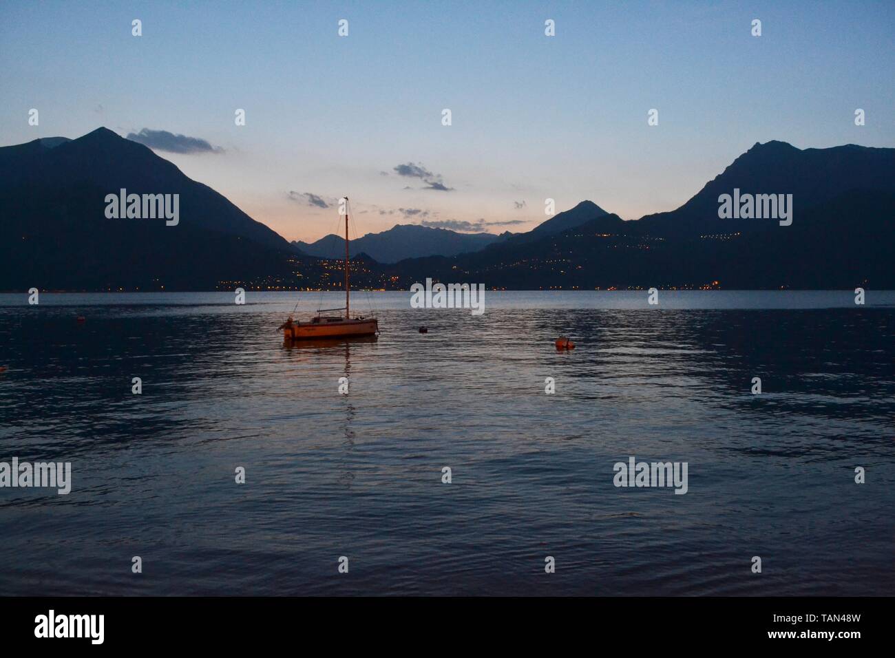 Beautiful panoramic view to the lake Como with sailing boat anchored ...