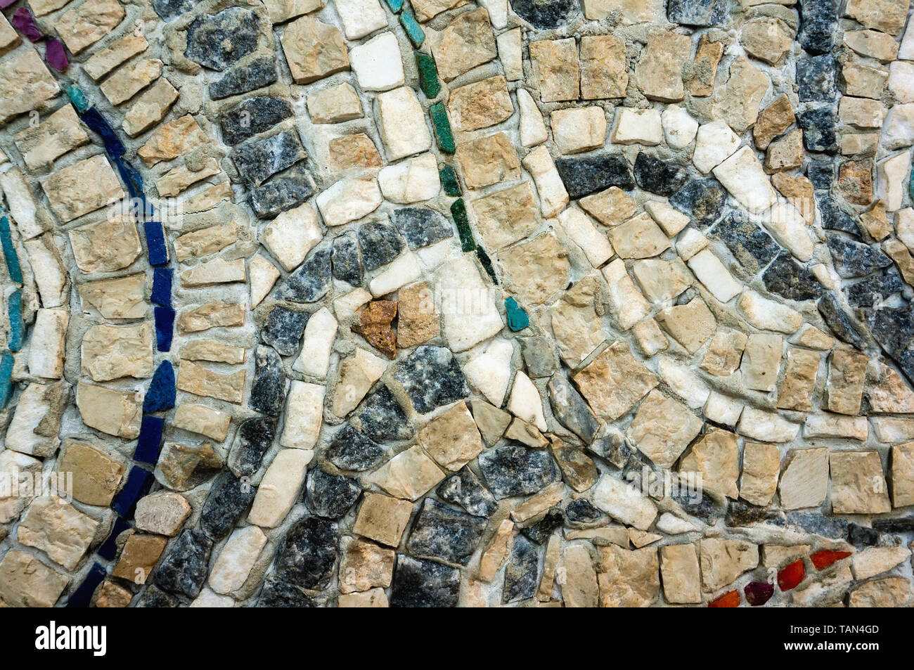 A fragment of the wall of small colored stones. The texture of the ...