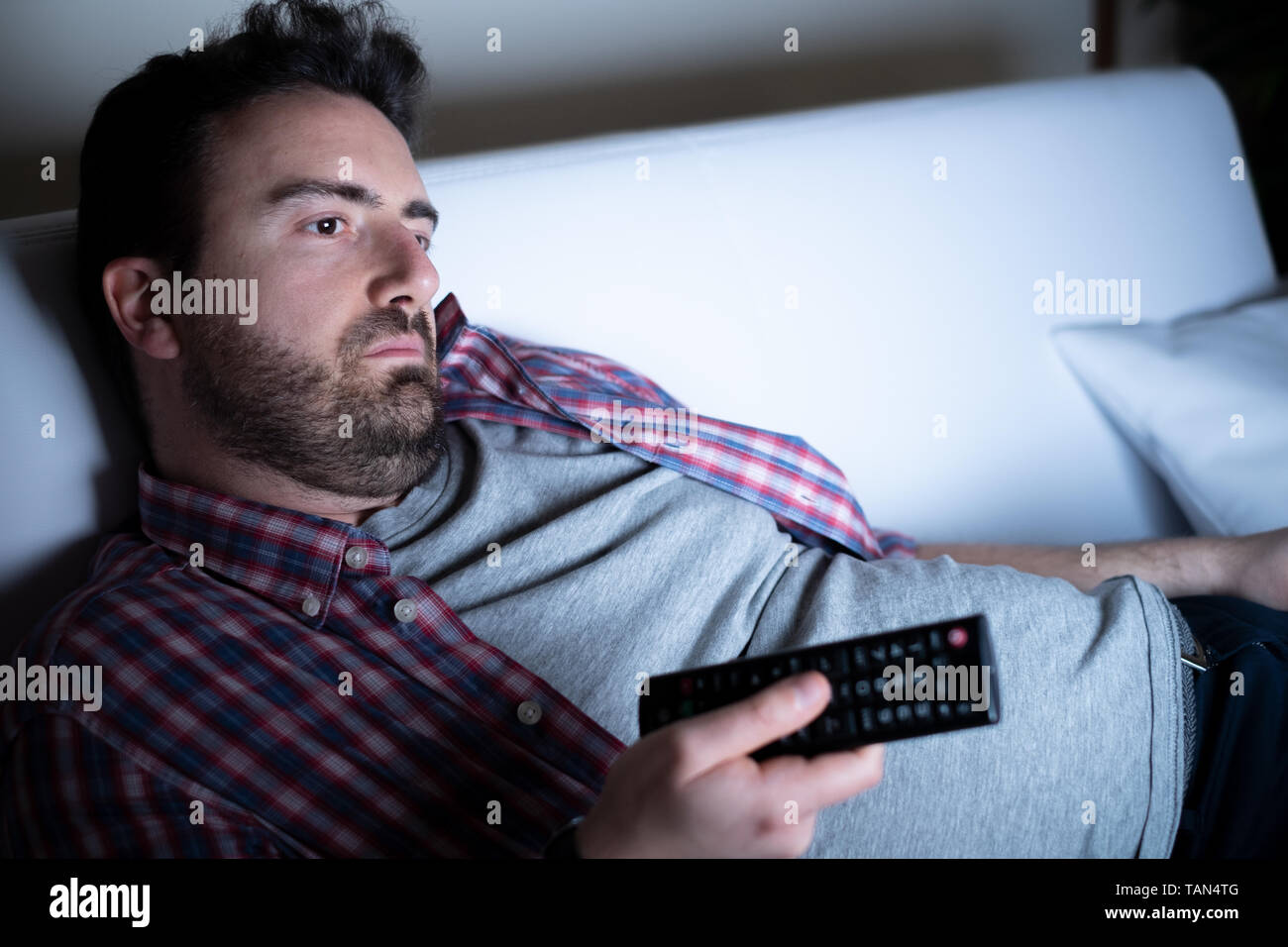 Portrait of one caucasian man watching tv Stock Photo - Alamy