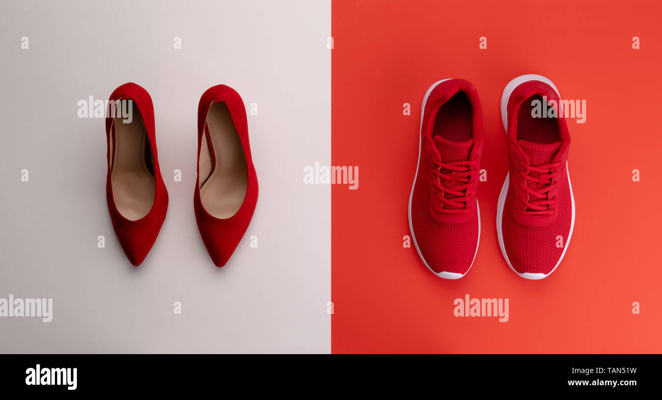 A studio shot of pair of running vs high heel shoes on color background ...