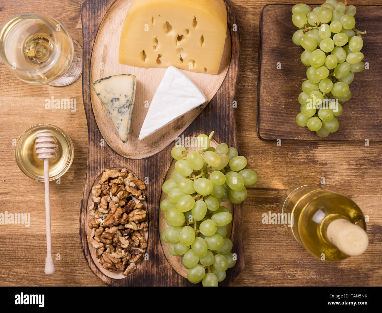 Top view of food compositon of fresh grapes next to various cheeses ...