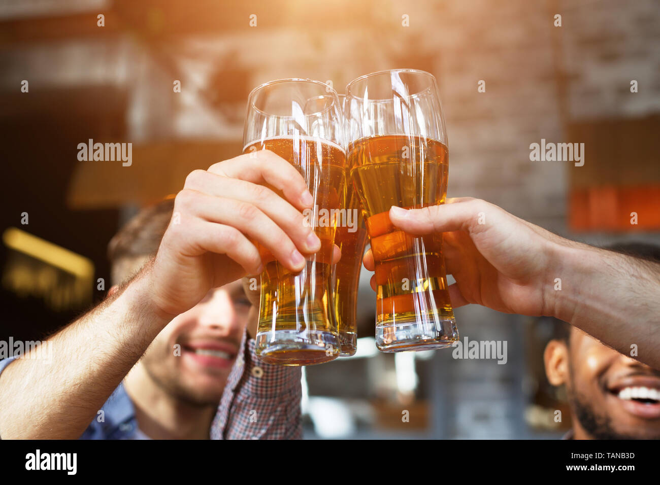 Cheers For Us. Men Drinking Draft Beer And Clinking Glasses Stock Photo ...