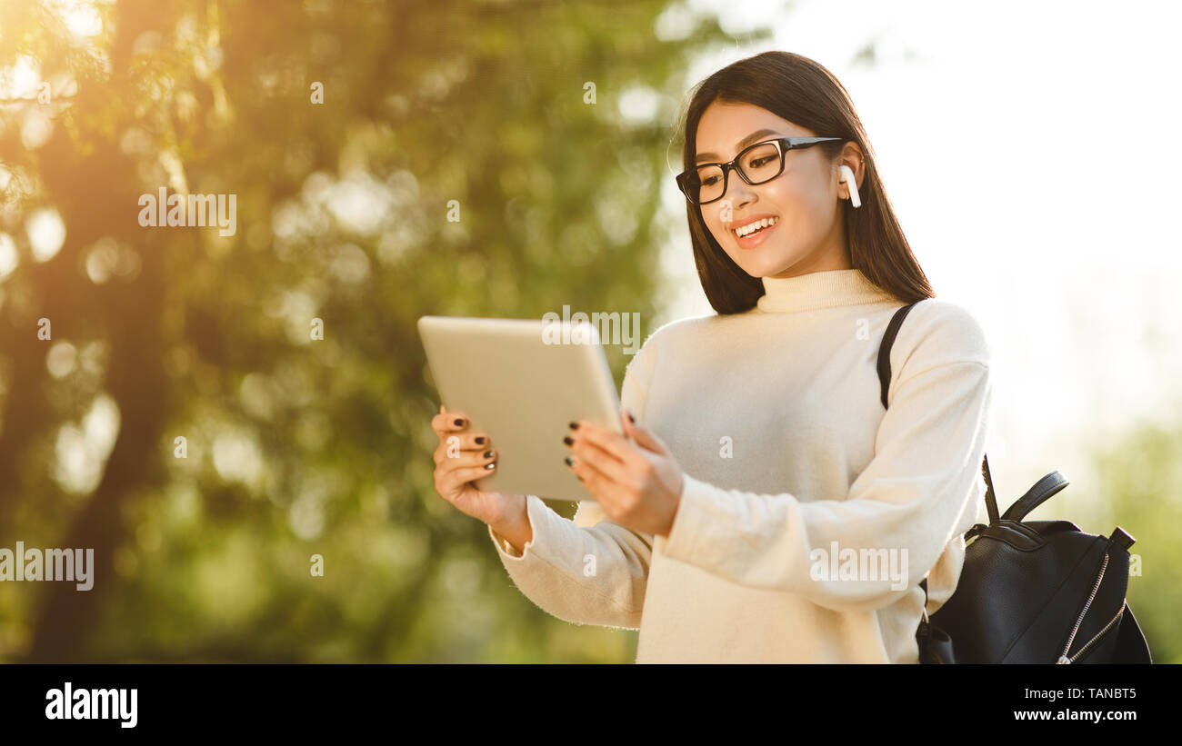 Asian Girl Using Tablet, Searching Place By Gps Stock Photo - Alamy