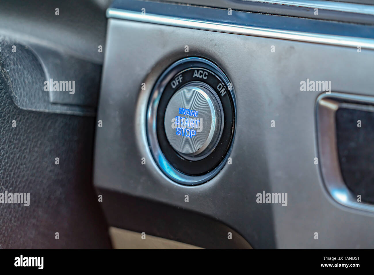 Close up view of an engine push start and stop button inside a vehicle ...