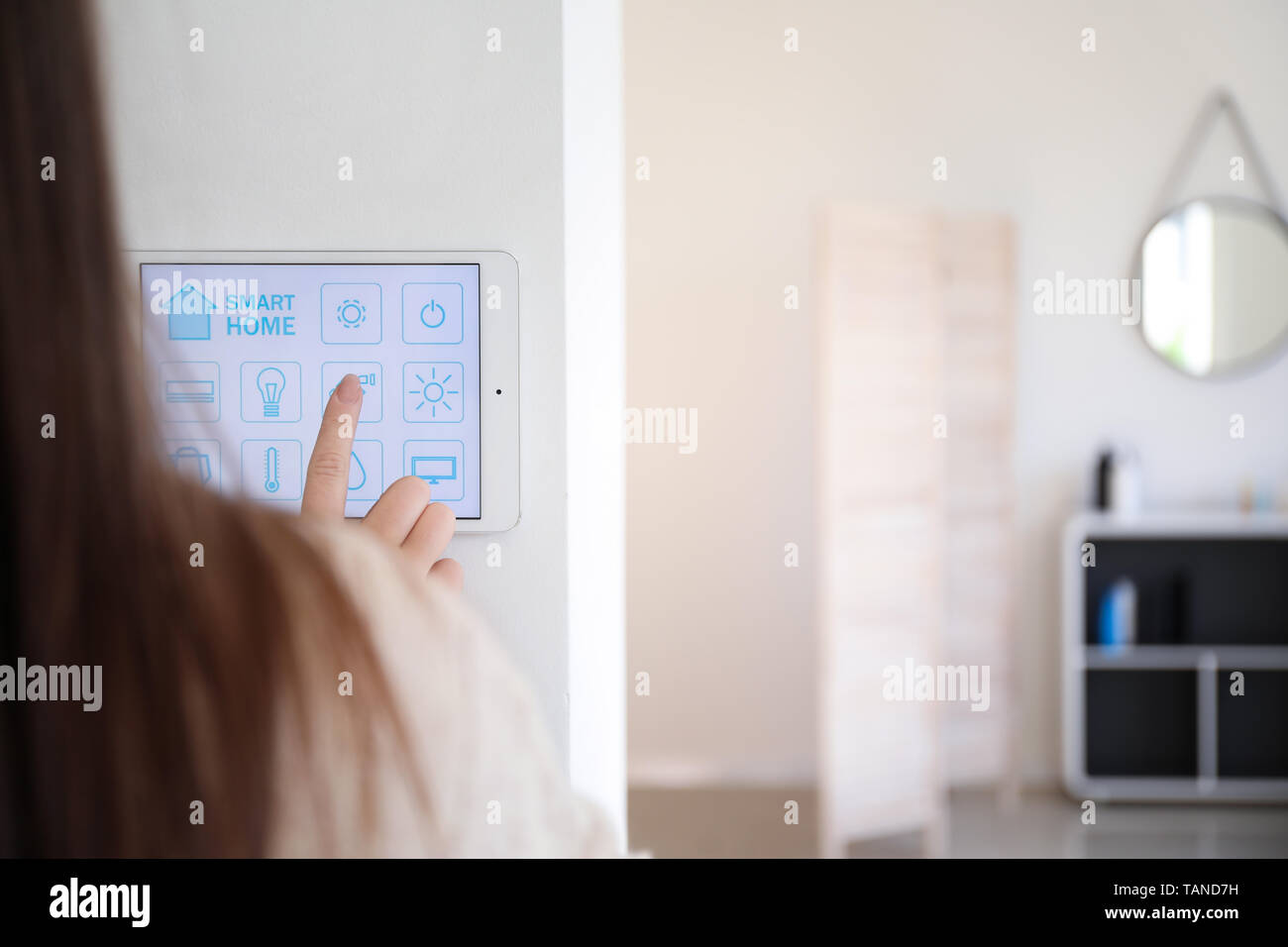 Young woman using application of smart home automation Stock Photo - Alamy