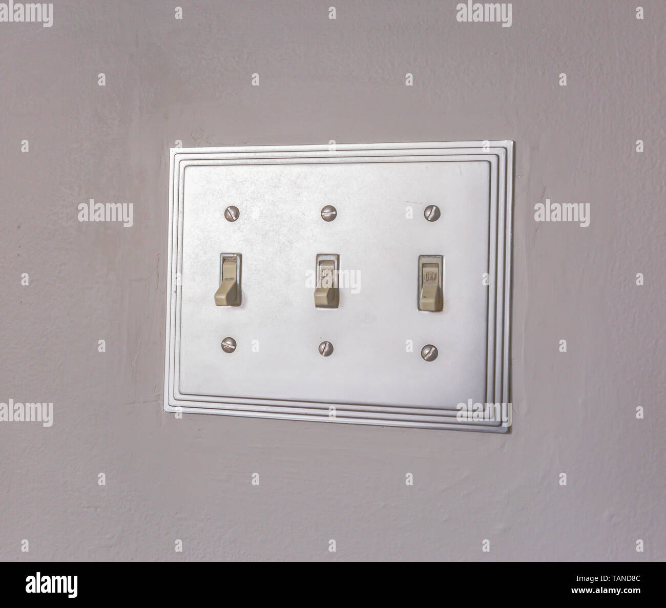 Close up of the electrical light switch against the white wall of a ...