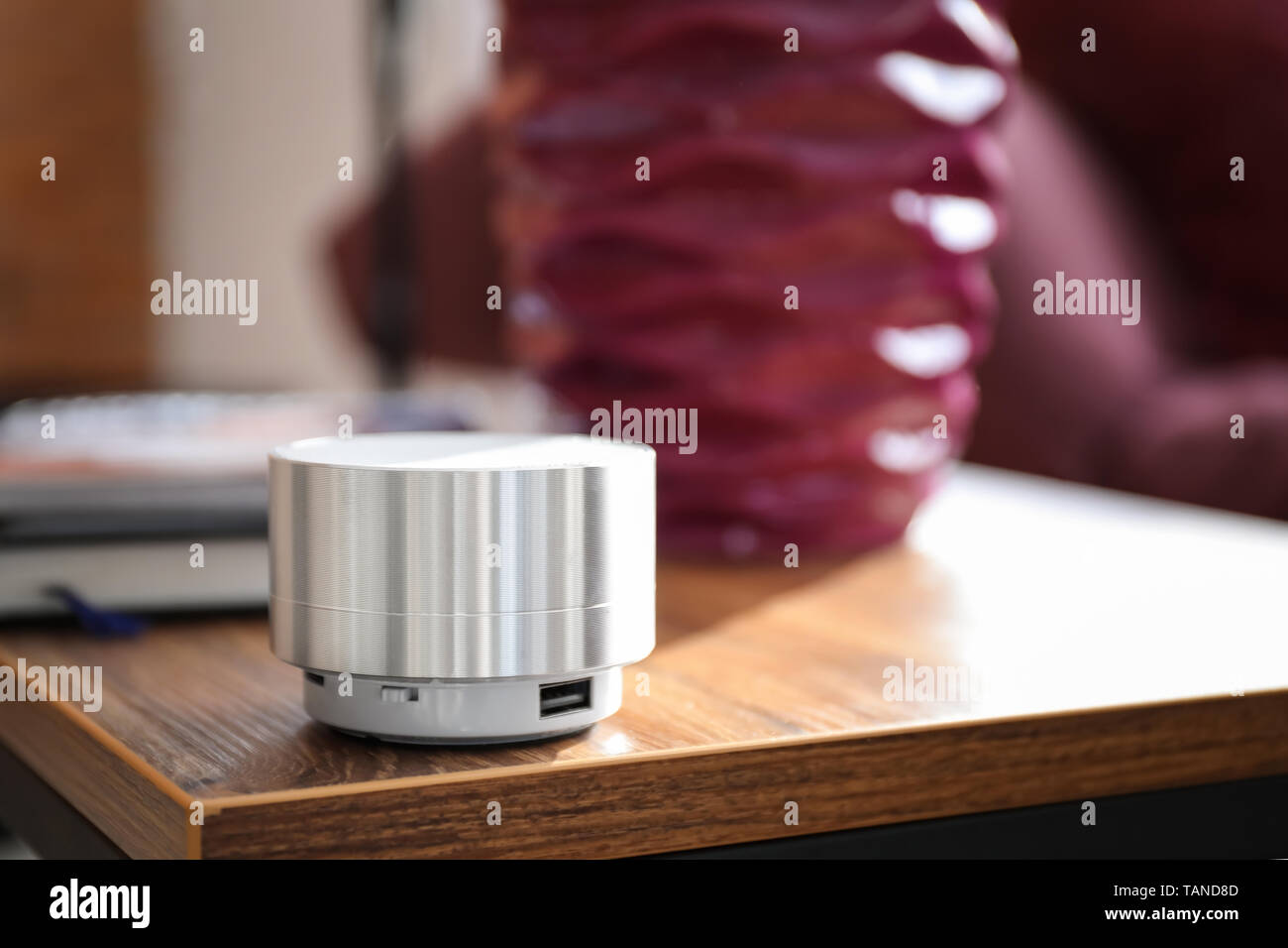 Smart home assistant device on table in room Stock Photo - Alamy