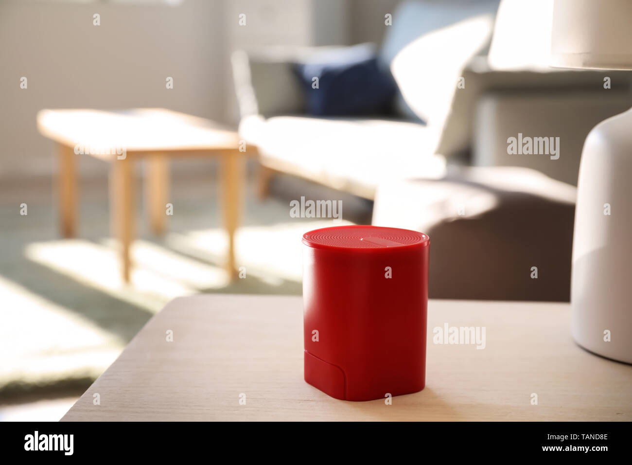 Smart home assistant device on table in room Stock Photo - Alamy