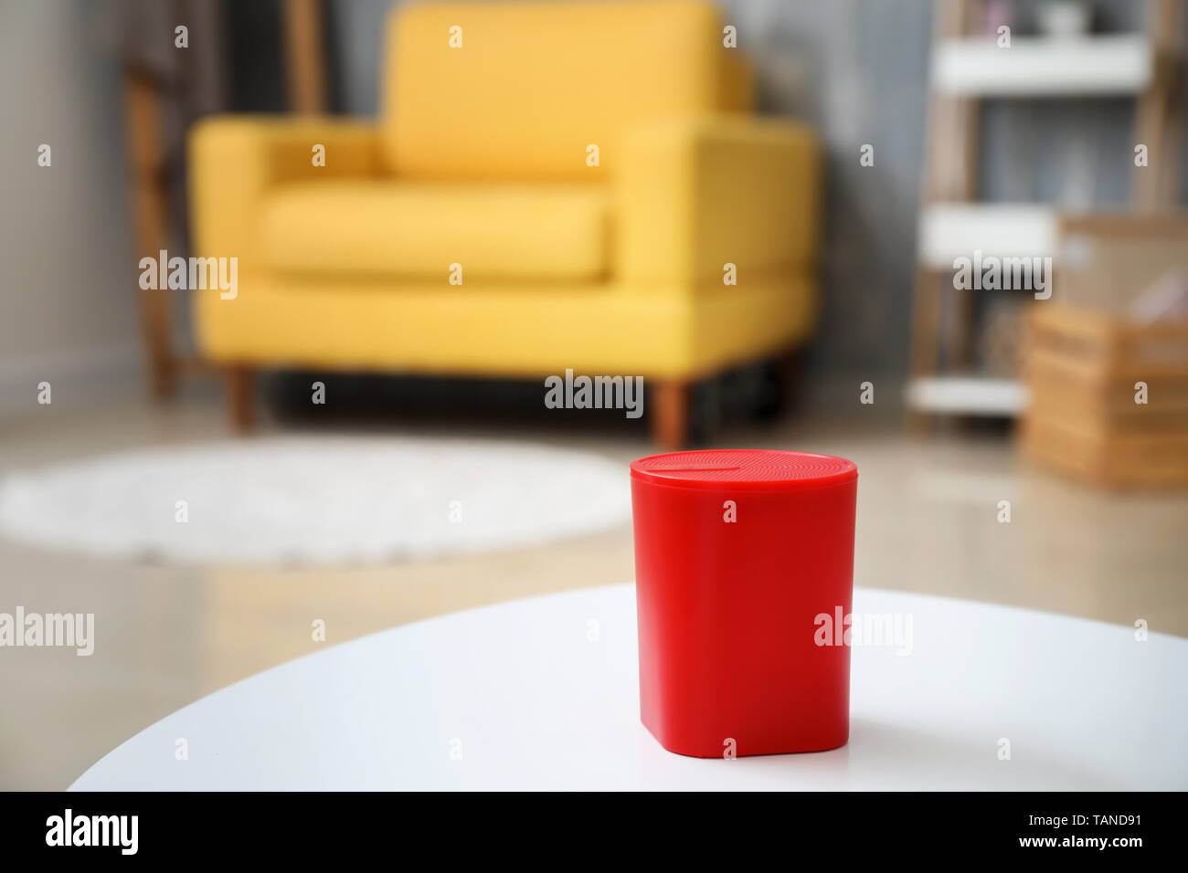 Smart home assistant device on table in room Stock Photo - Alamy