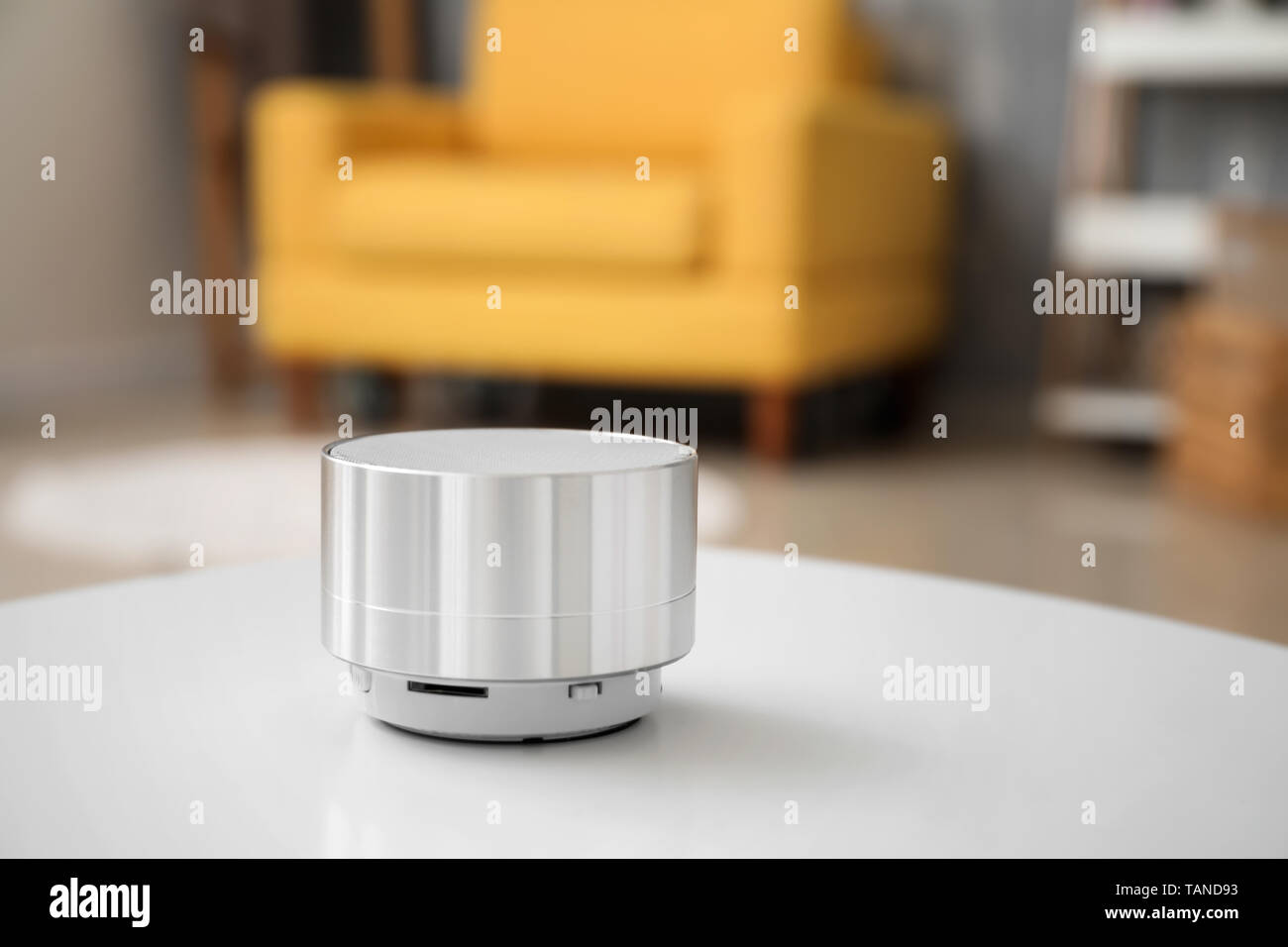 Smart home assistant device on table in room Stock Photo - Alamy