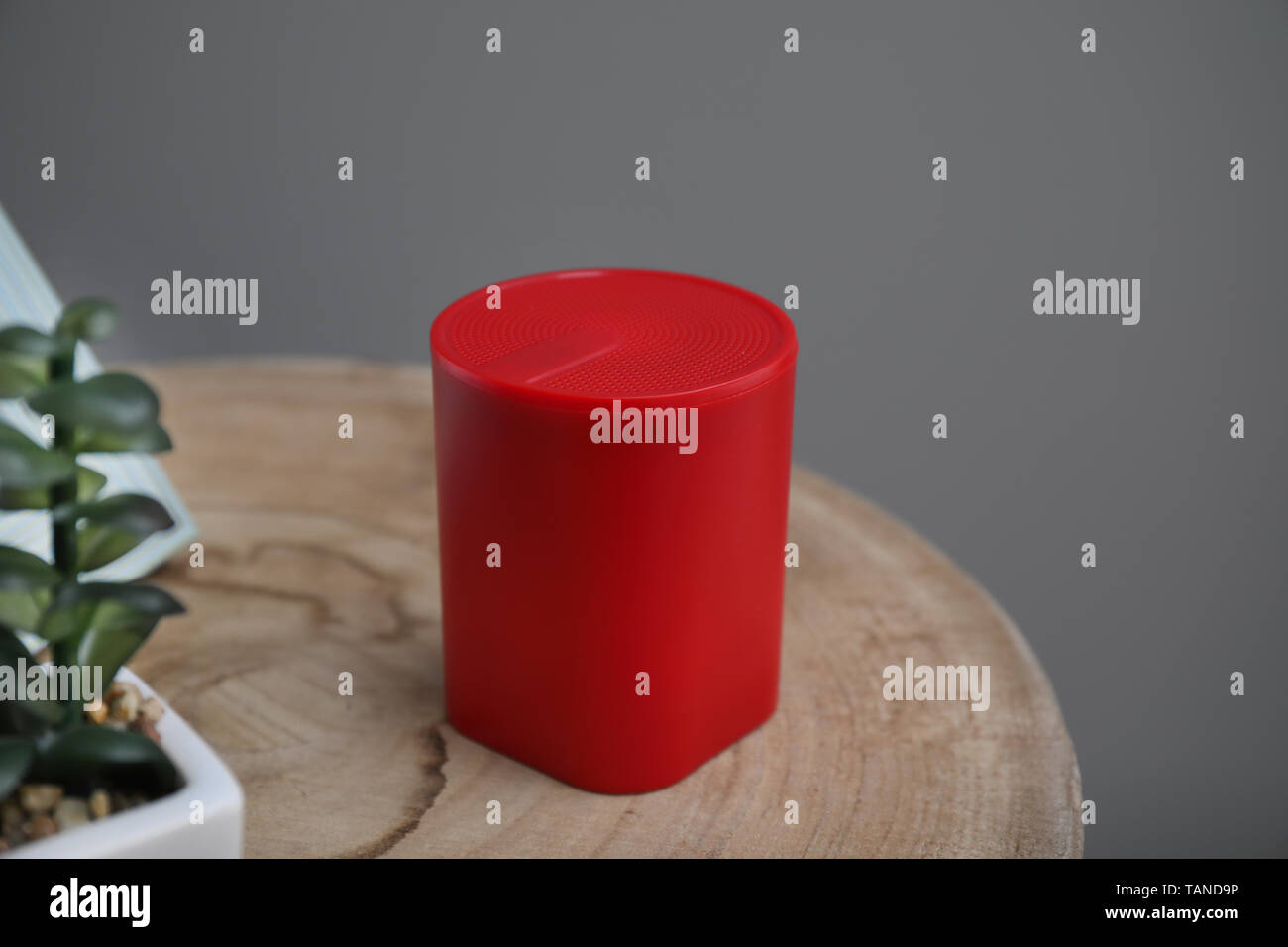 Smart home assistant device on table against grey background Stock ...