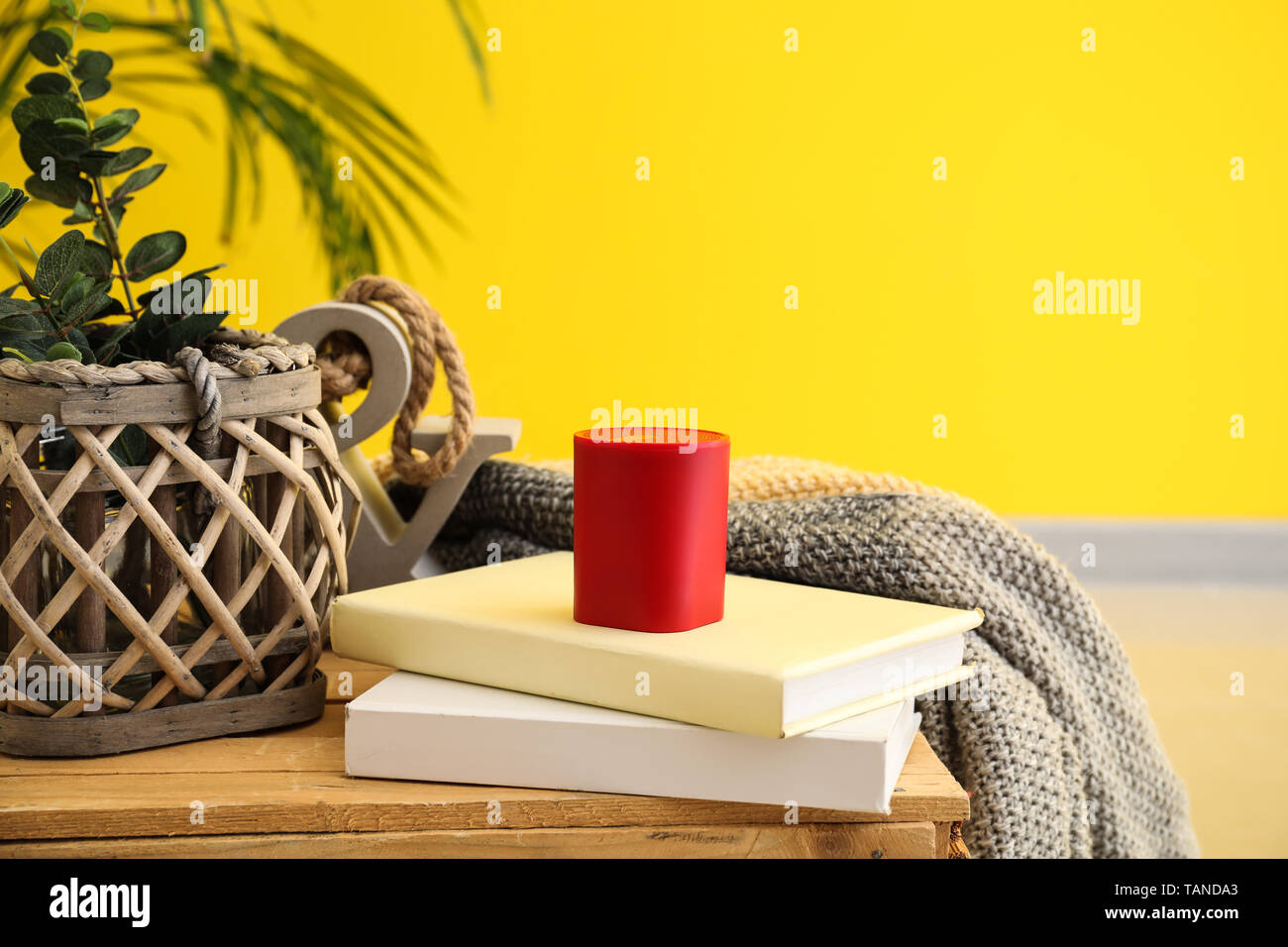 Smart home assistant device and books on table in room Stock Photo - Alamy