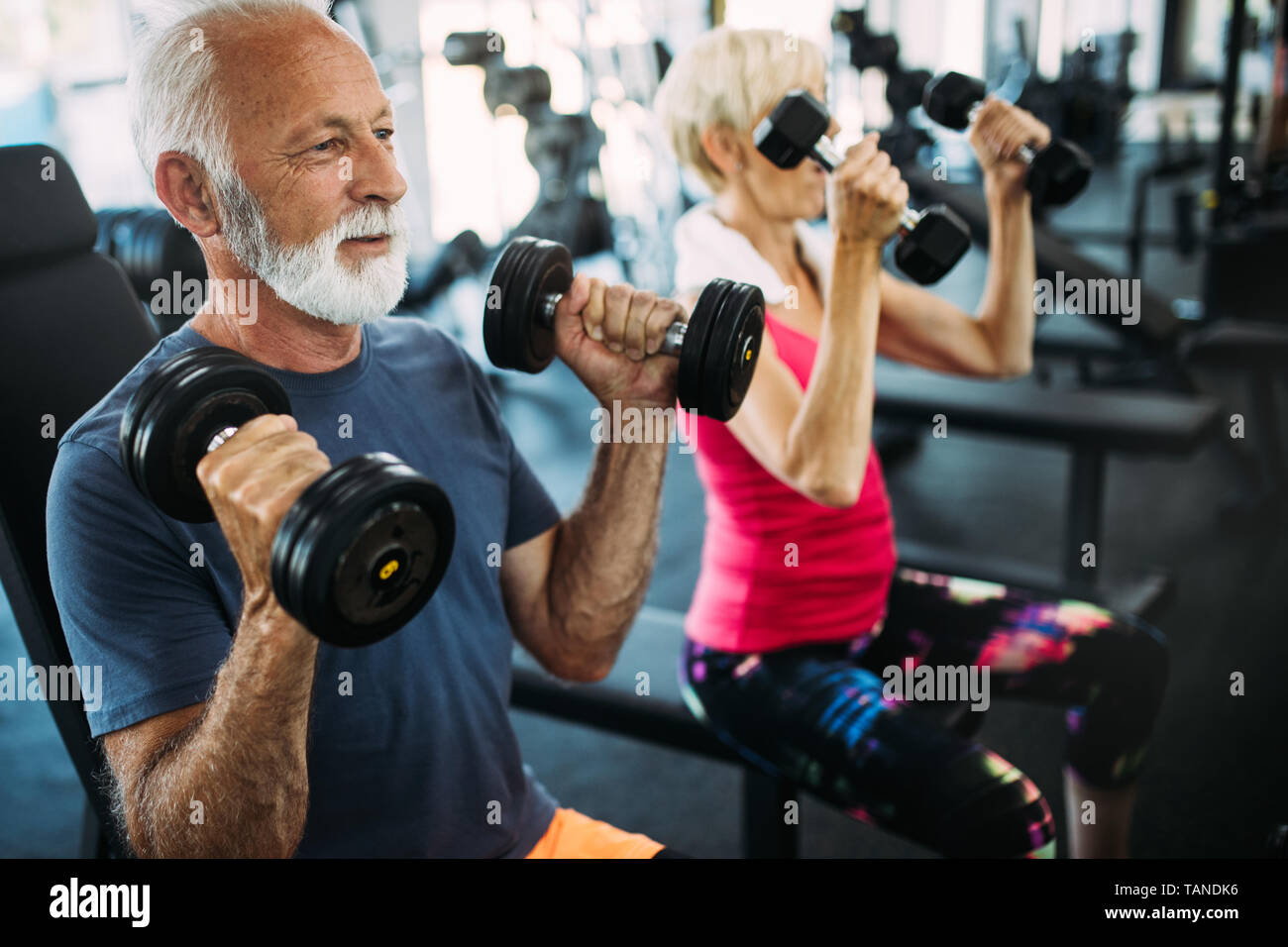 Mature fit couple exercising in gym to stay healthy Stock Photo - Alamy