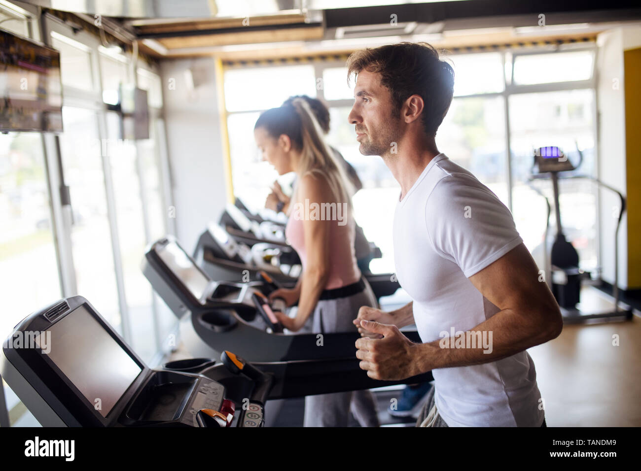 Beautiful fit people exercising together in gym Stock Photo - Alamy