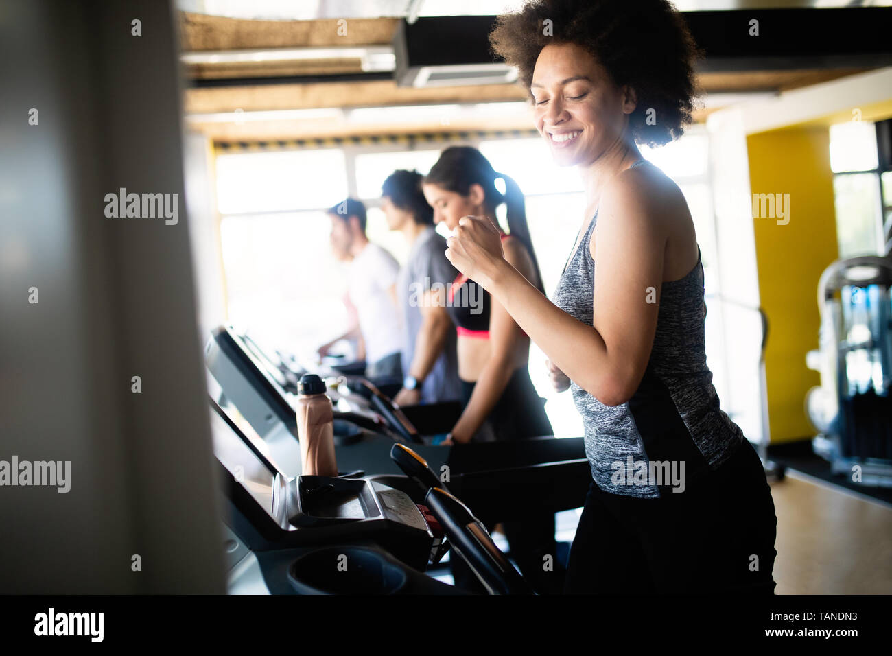 Beautiful fit people exercising together in gym Stock Photo - Alamy