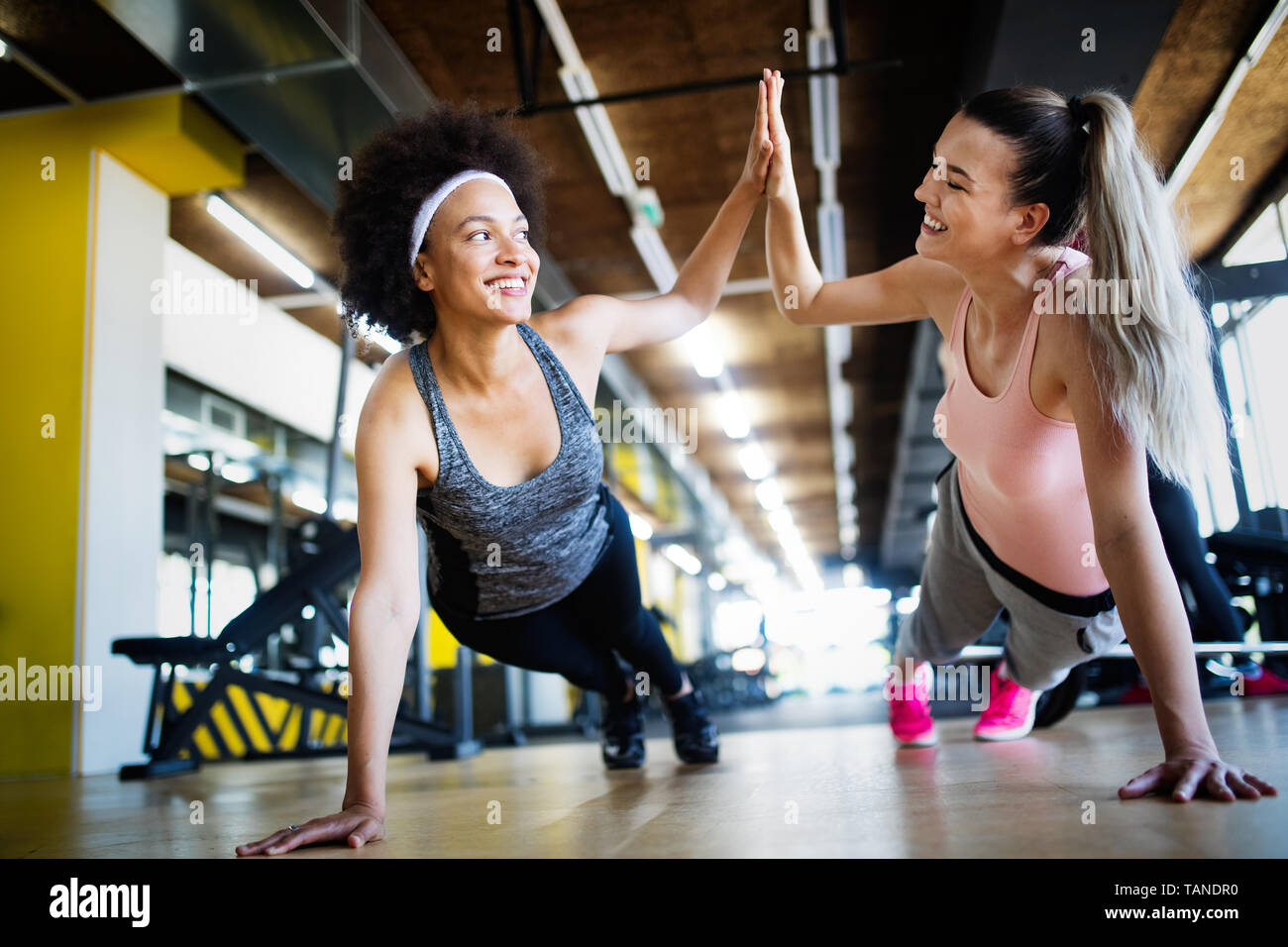 Beautiful fit women exercising together in gym Stock Photo - Alamy