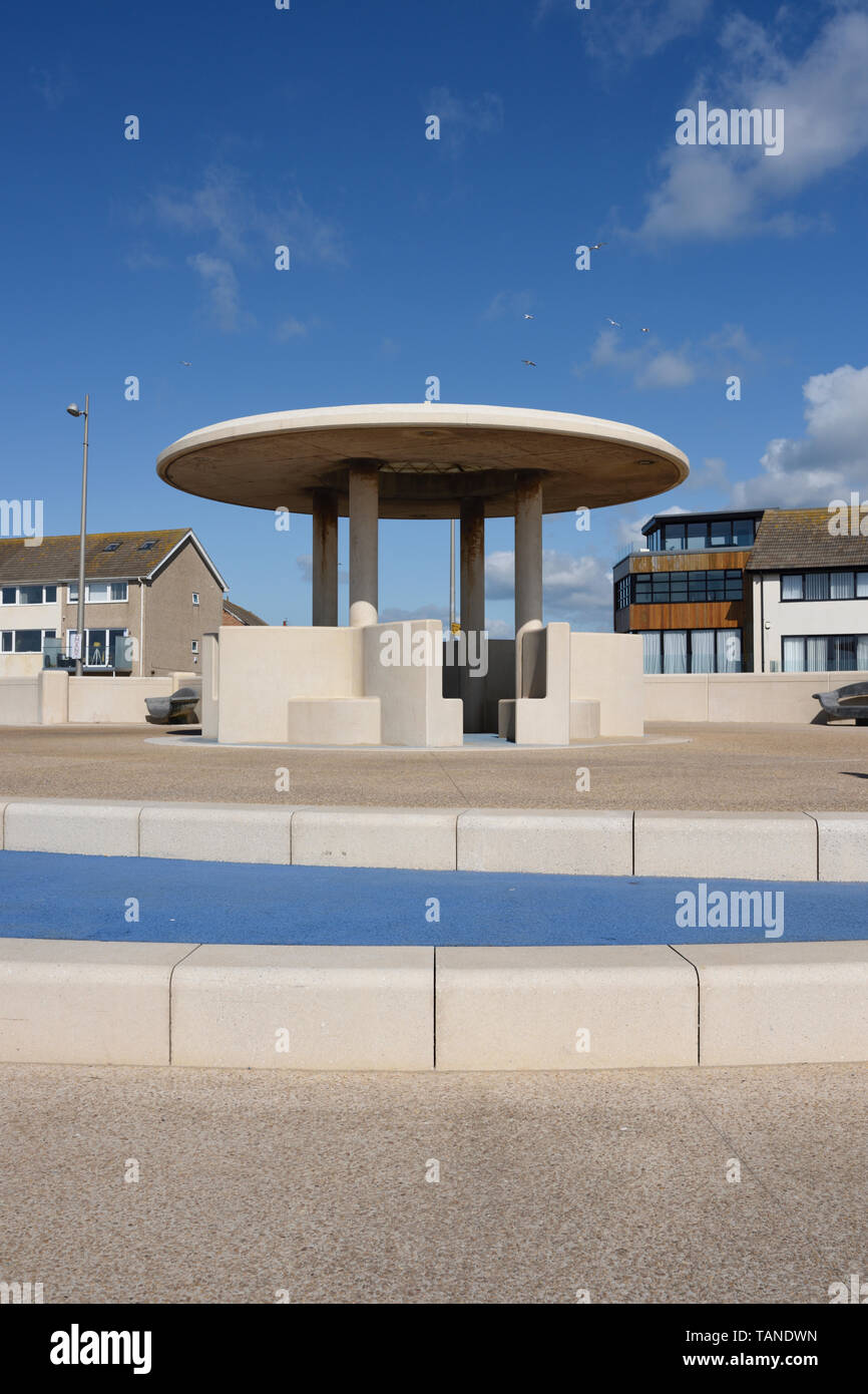 Stepped promenade and concrete seafront shelter in foreground with ...