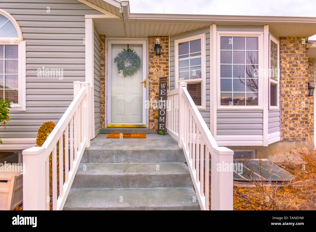 Pleasing home with stairs and half hexagon shaped window at the facade ...