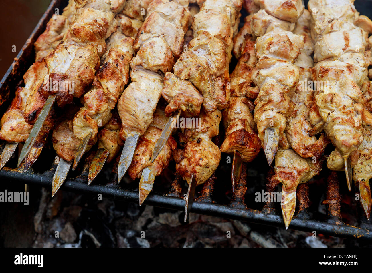 Grilled meat skewers, shish kebab on BBQ grill hot coals with smoke ...