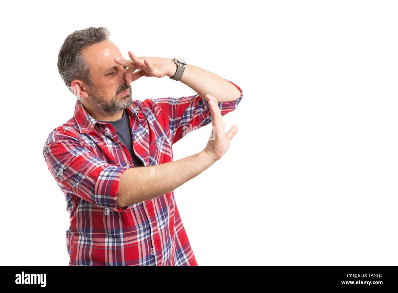 Man making stop or wait gesture with palm as holding nose because of ...