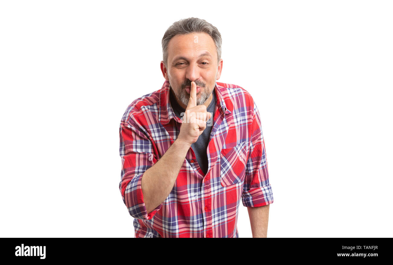 Smiling man wearing red plaid shirt making shush gesture by touching ...