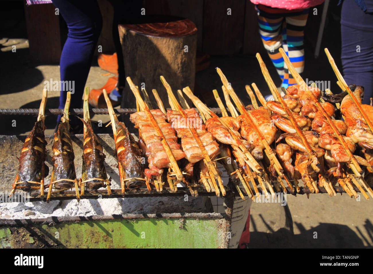 Close up of traditional barbecue street food with fishes and chicken ...