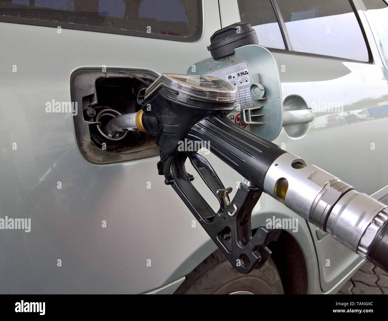 Car at a gas station. Gasoline pistol pump inserted in a tank Stock ...