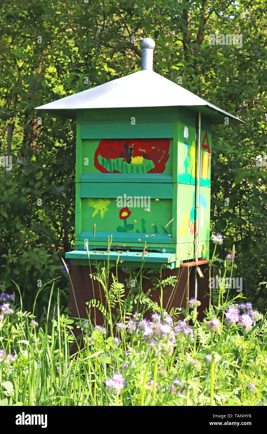 colorful painted beehive in a green and blooming meadow Stock Photo - Alamy