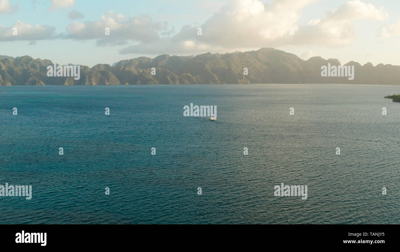 Aerial view seascape bay with islands and mountains sunset. tour boat ...