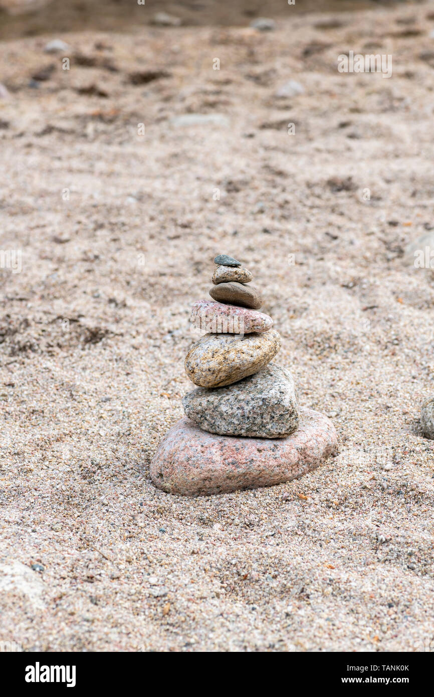 Balanced stones stack surrounded by sand, Zen meditation spa relaxation ...