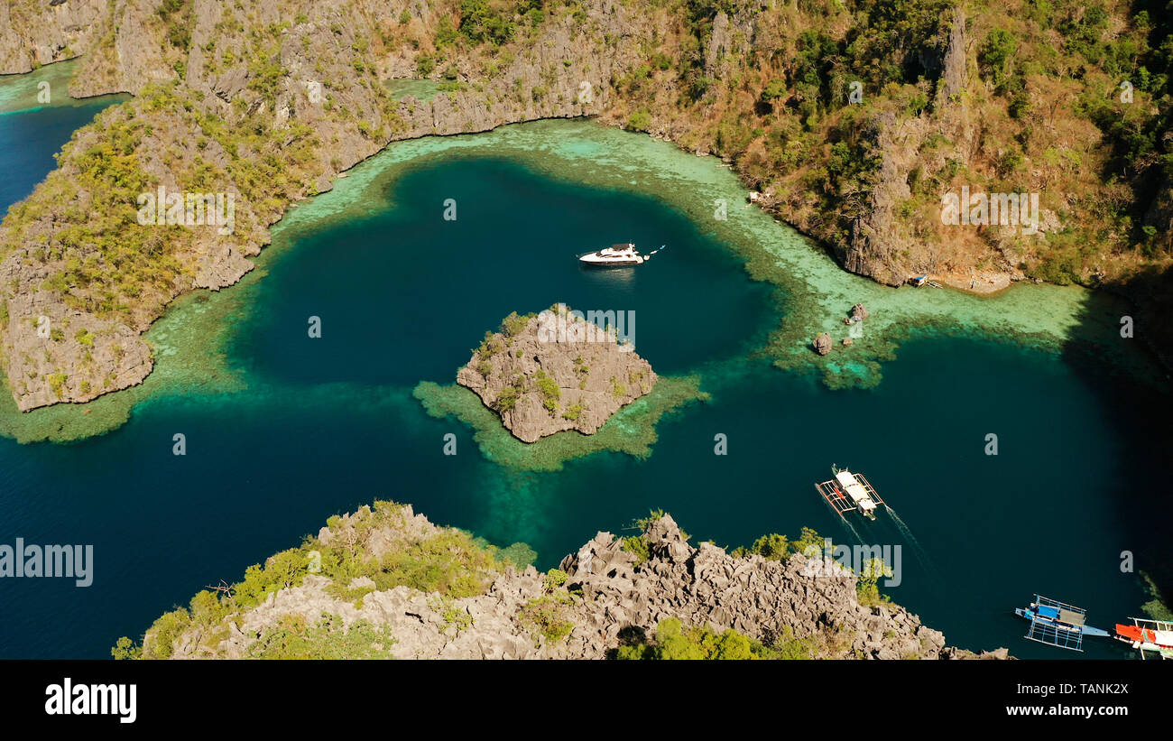Aerial view tourist boats in lagoon. Kayangan Lake. lagoons, mountains ...