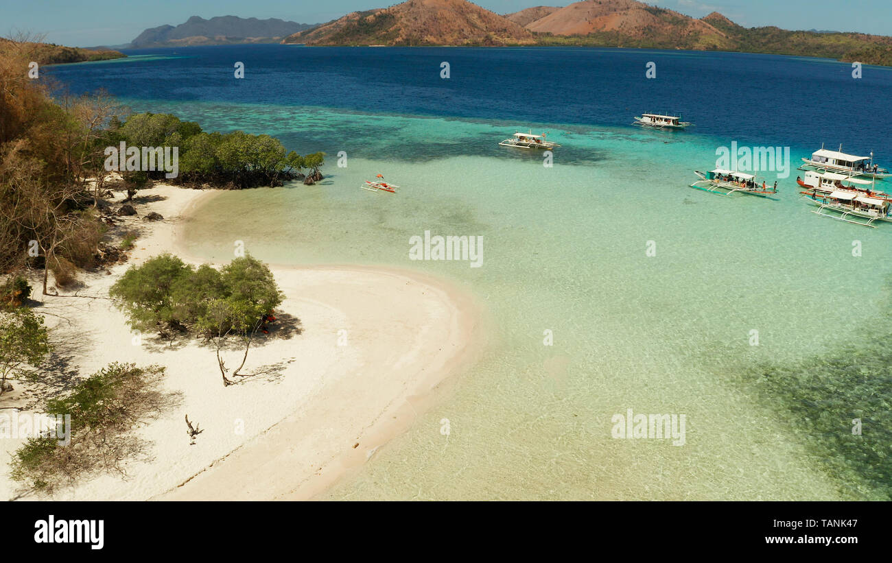 aerial view tropical island with sand white beach, clear and blue water ...