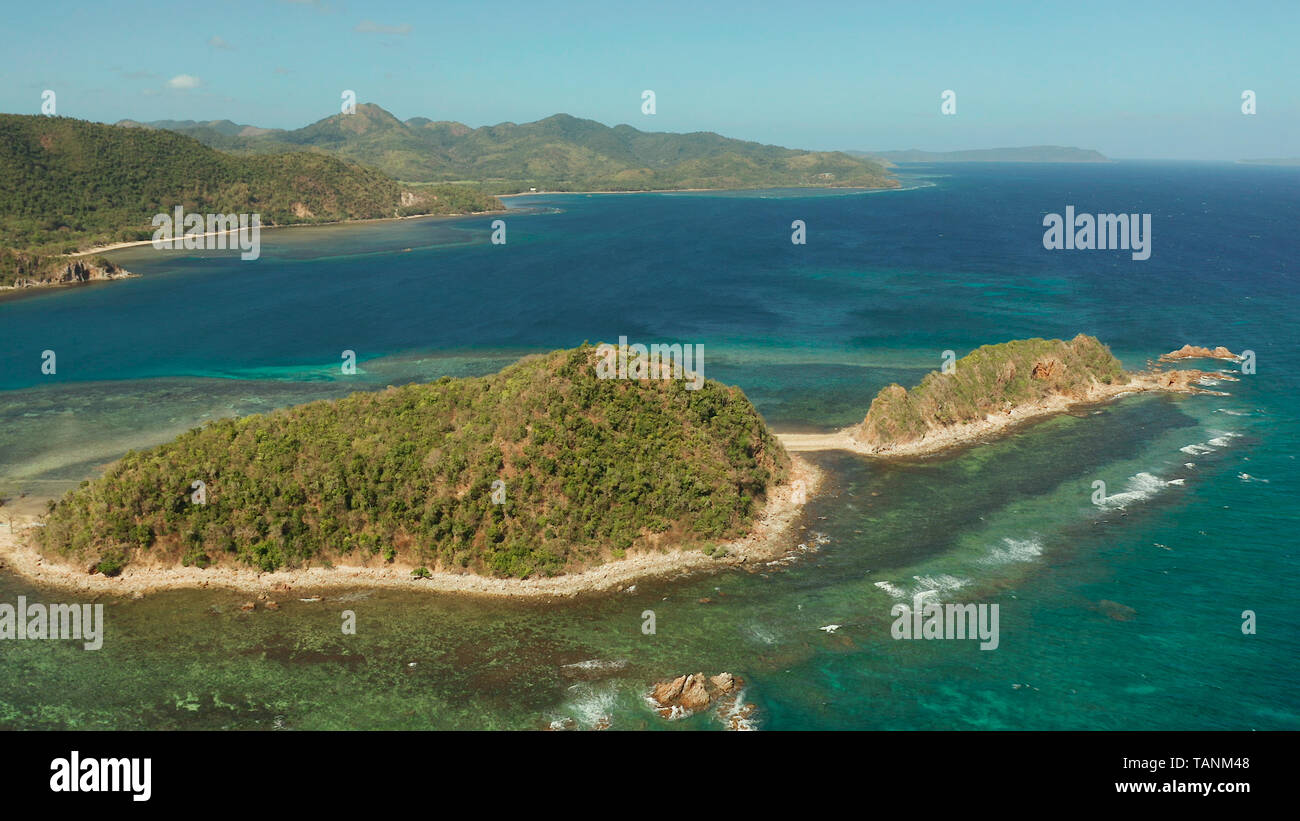 aerial view tropical island in blue lagoon, coral reef and big wave ...