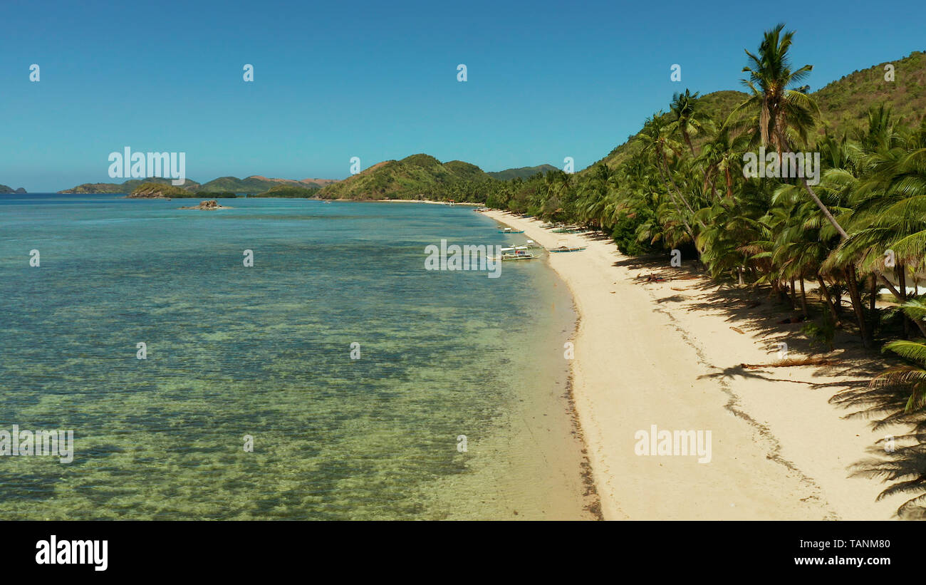Aerial view tropical island with beach, coral reef and blue lagoon ...