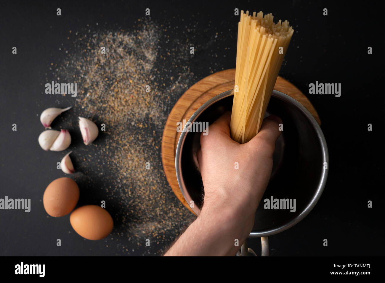 top view of raw hard spaghetti in a metal pot, boiling water ...