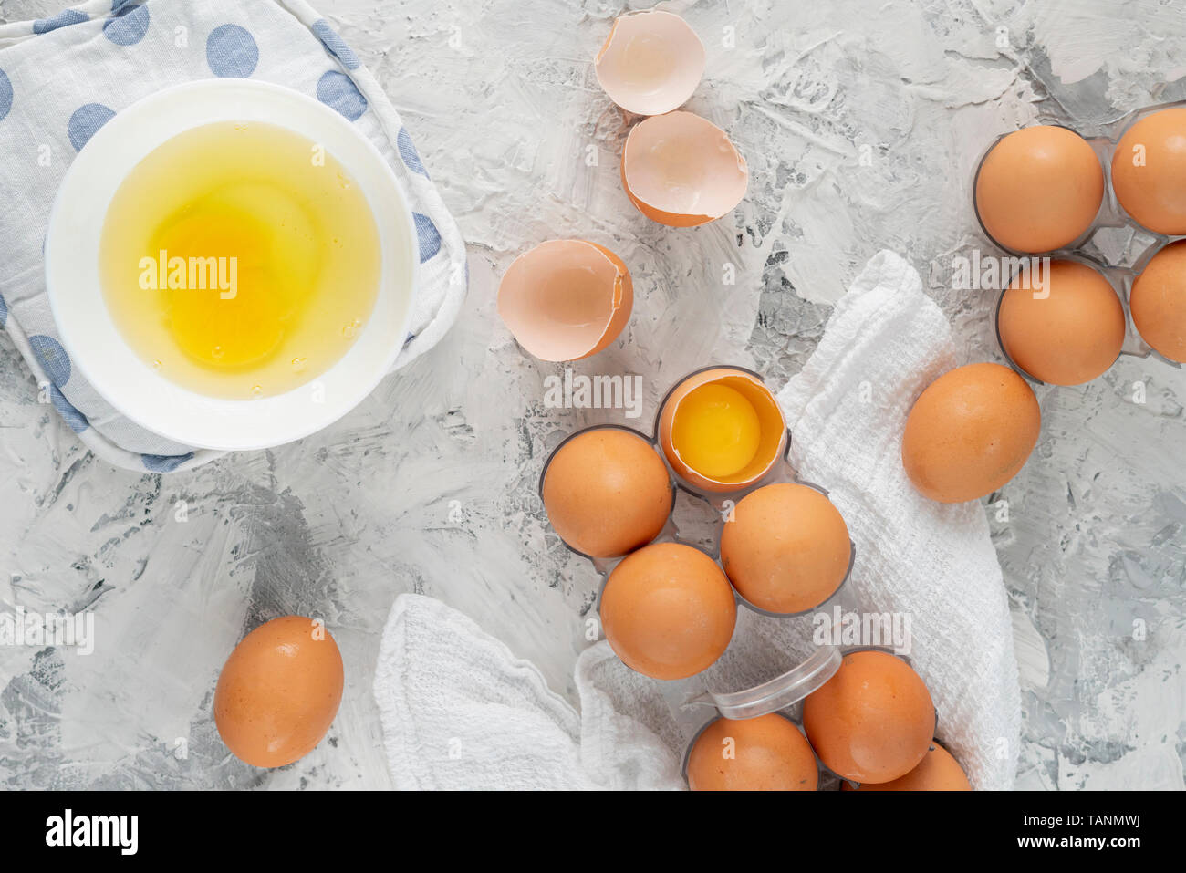 many raw uncooked chicken eggs in a plastic tray on the grunge table ...
